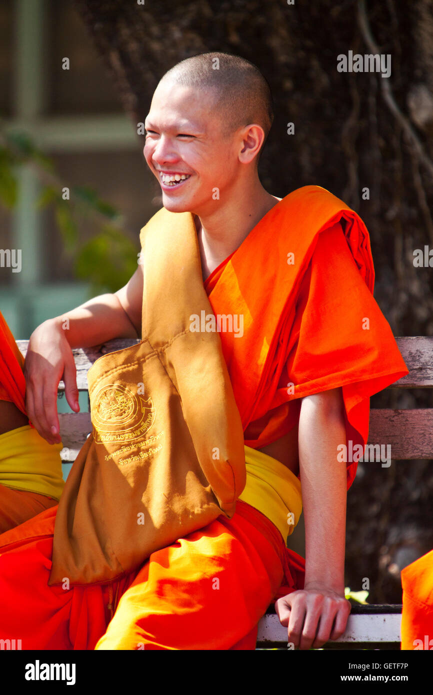A Buddhist monk sat smiling in the sunshine Stock Photo - Alamy