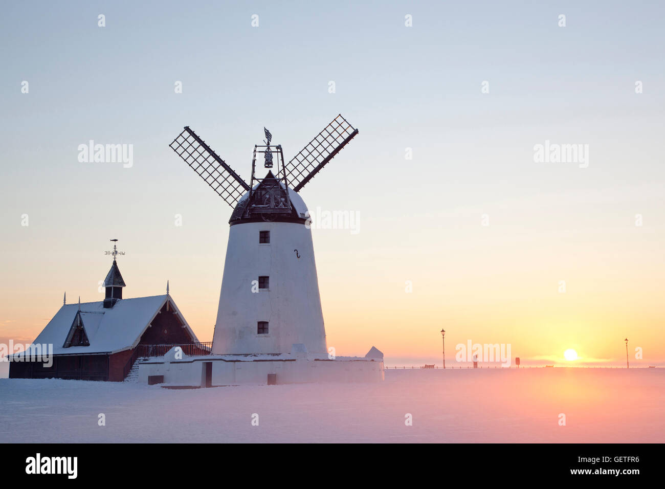 The white windmill in Lytham St Annes at sunset with snow on the ground ...