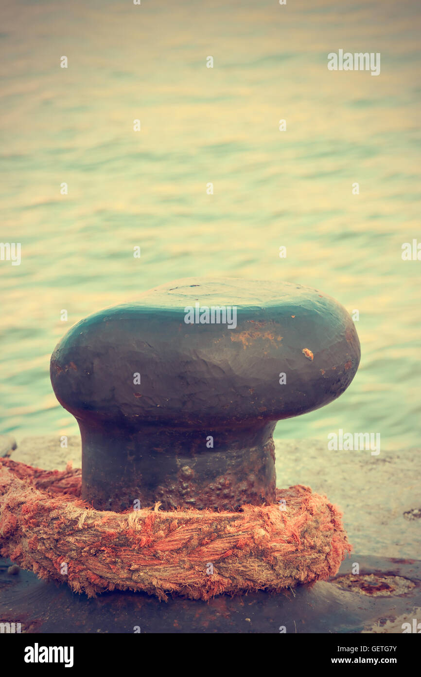 Iron pier with a big rope. Vintage style. Vertical image Stock Photo ...