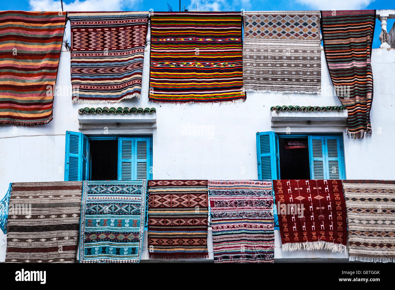 Carpets and rugs hanging out on display from a shop in the Place de la ...