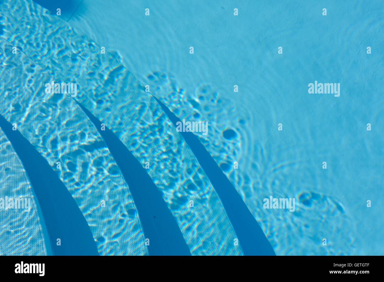 Shadow on water in swimming pool Stock Photo - Alamy