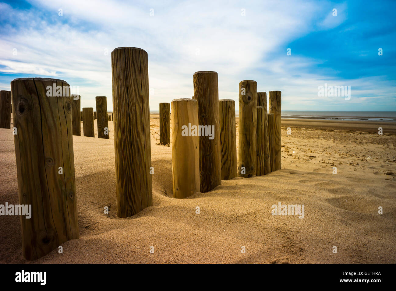 Posts driven into the sand to control erosion Stock Photo - Alamy