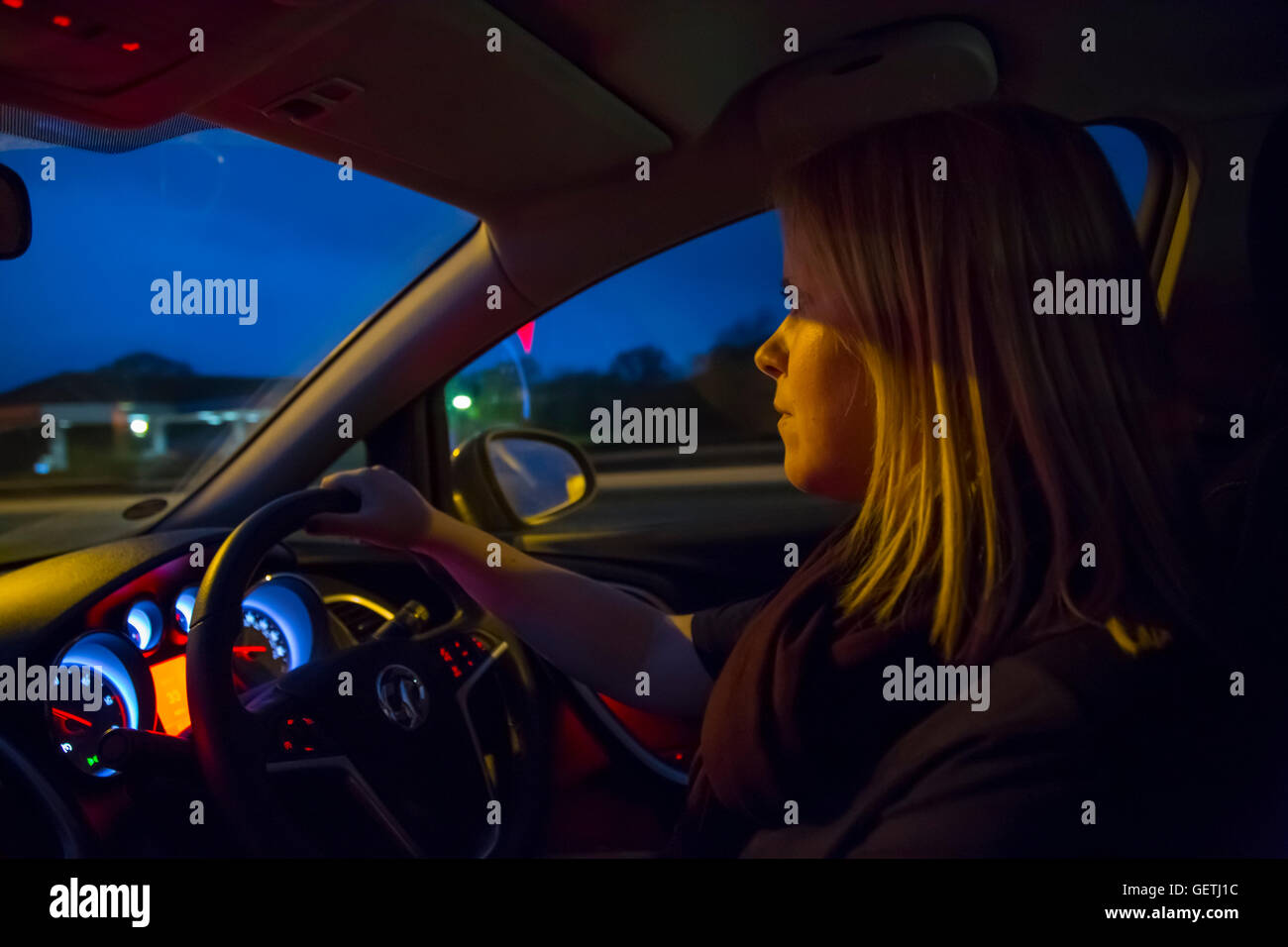 Young woman driving at night Stock Photo - Alamy