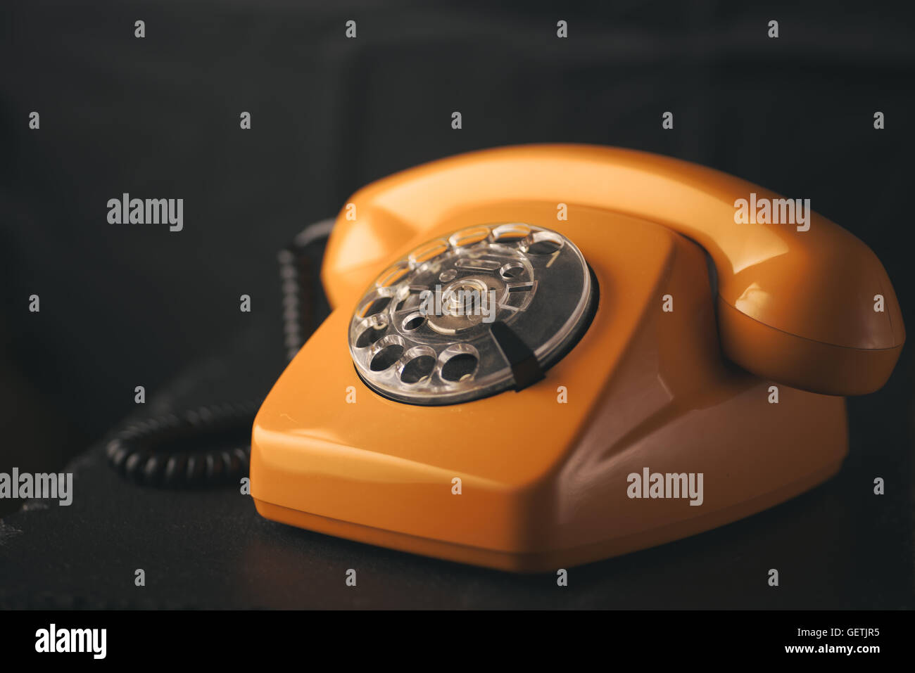 Vintage orange phone on black Stock Photo - Alamy