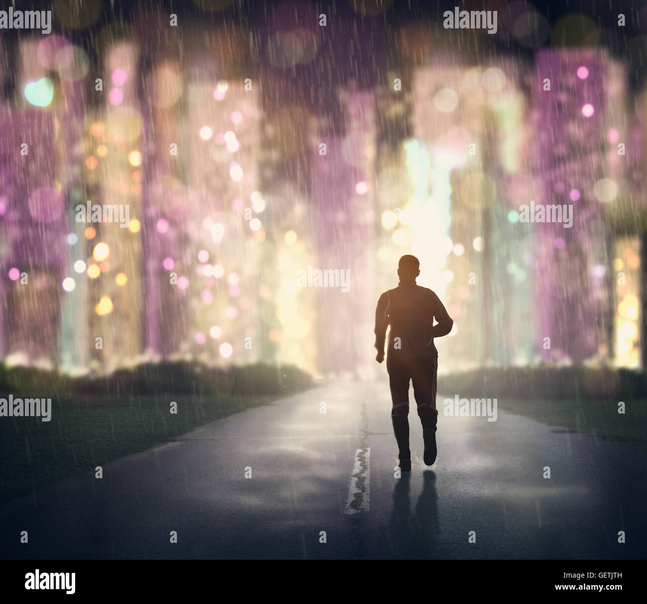 A man runs along the road at night in the rain Stock Photo - Alamy