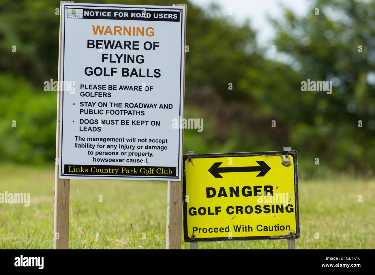 Warning signs where a road crosses a golf course Stock Photo - Alamy
