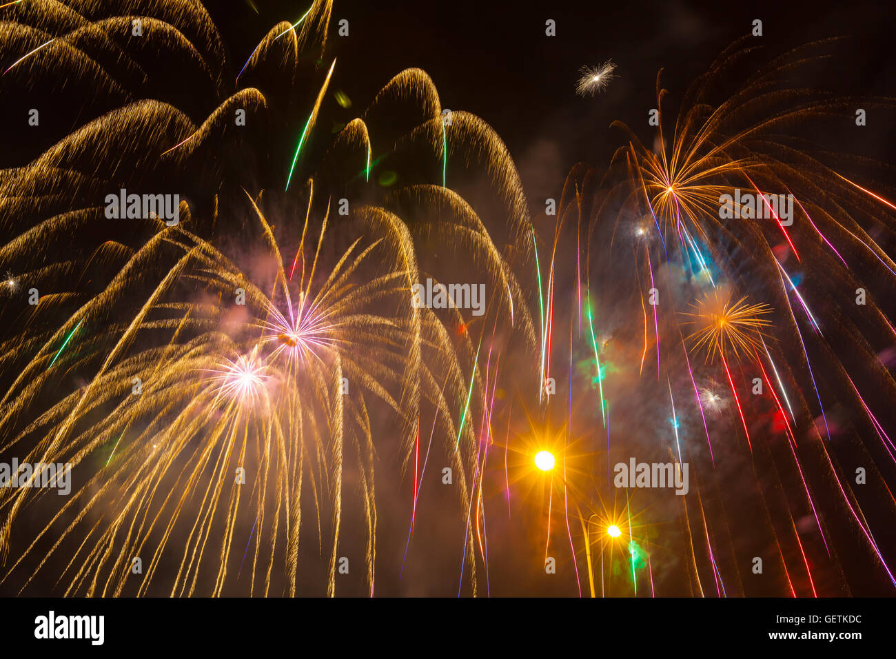 Multiple orange colorful fireworks falling trails Stock Photo - Alamy