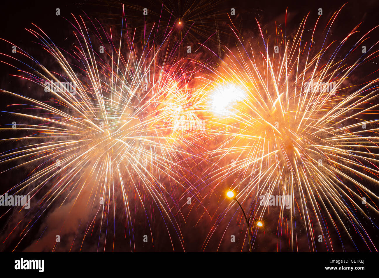 Multiple bright yellow red fireworks Stock Photo - Alamy