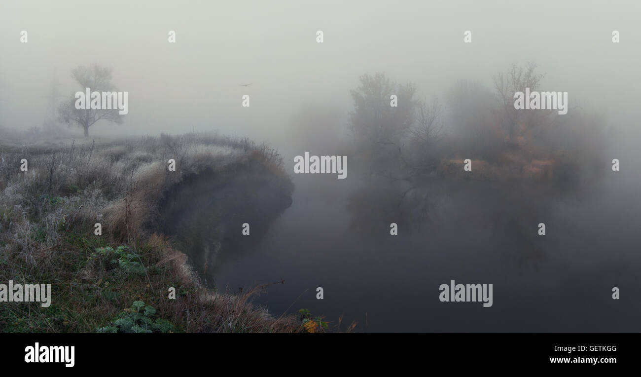 Misty landscape with a river Stock Photo - Alamy