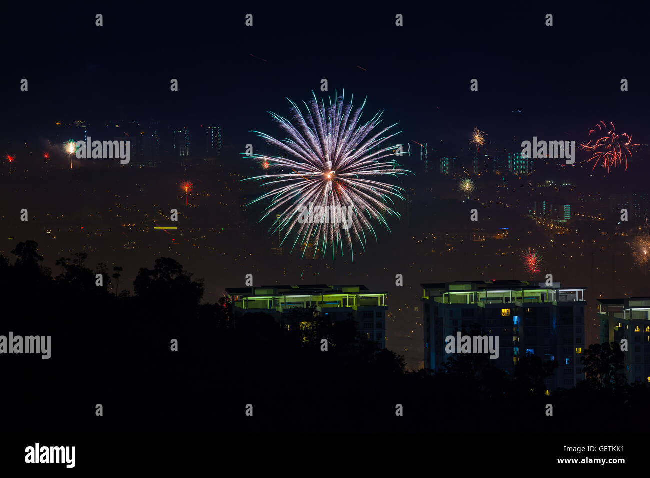Single fireworks burst above building and city Stock Photo - Alamy