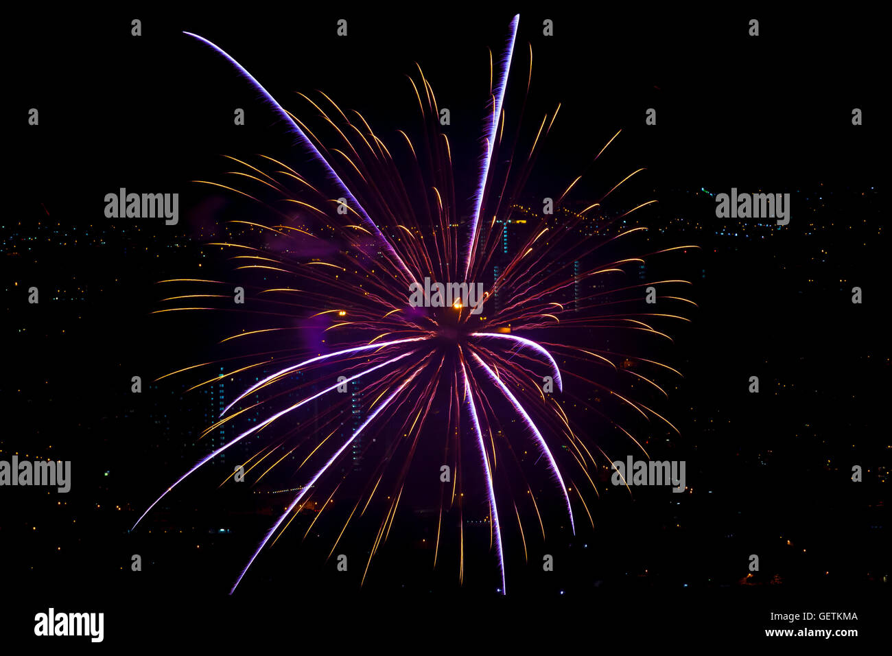 Single blue and orange fireworks burst with trails 1 Stock Photo - Alamy