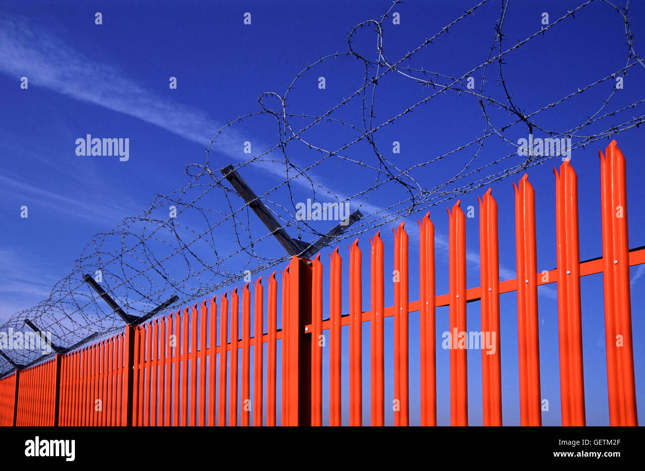 Brabed wire topped security fence Stock Photo - Alamy