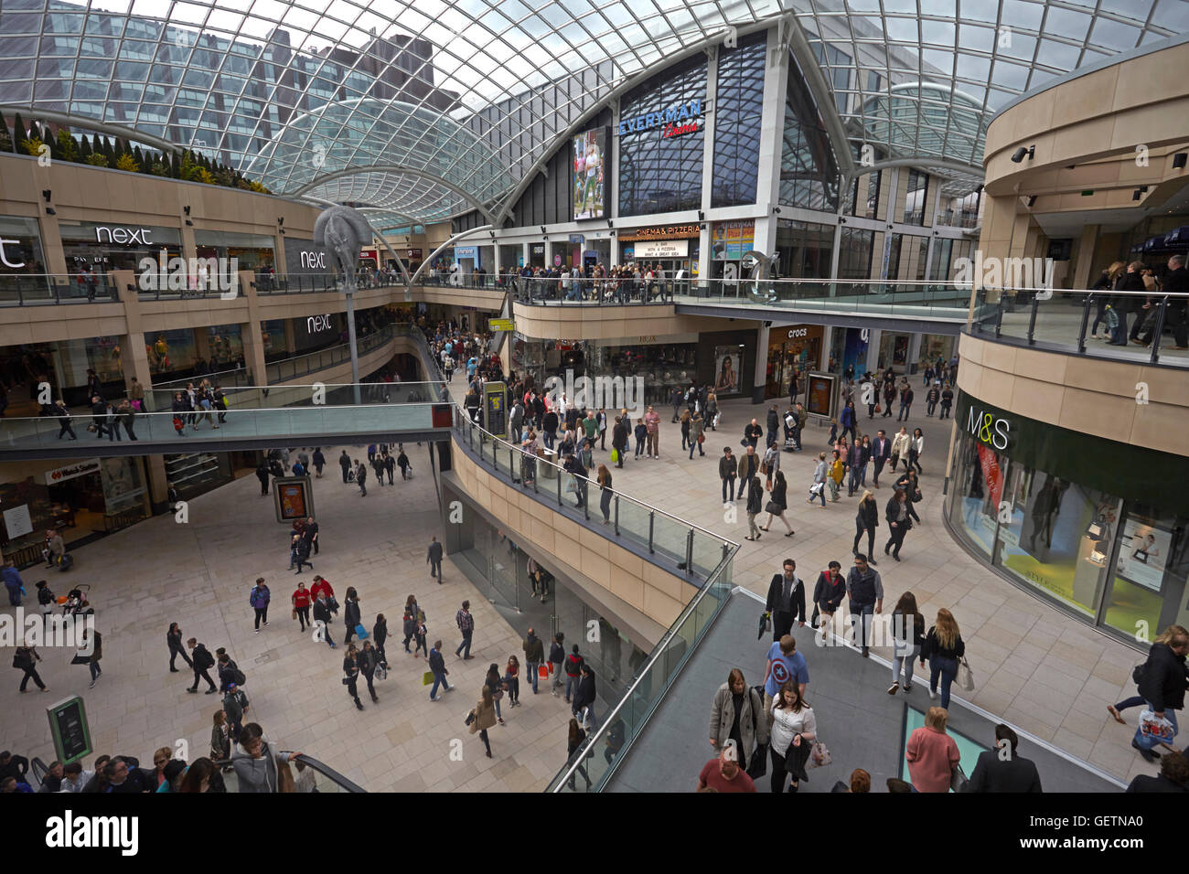 People shopping in busy indoor retail mall Stock Photo - Alamy