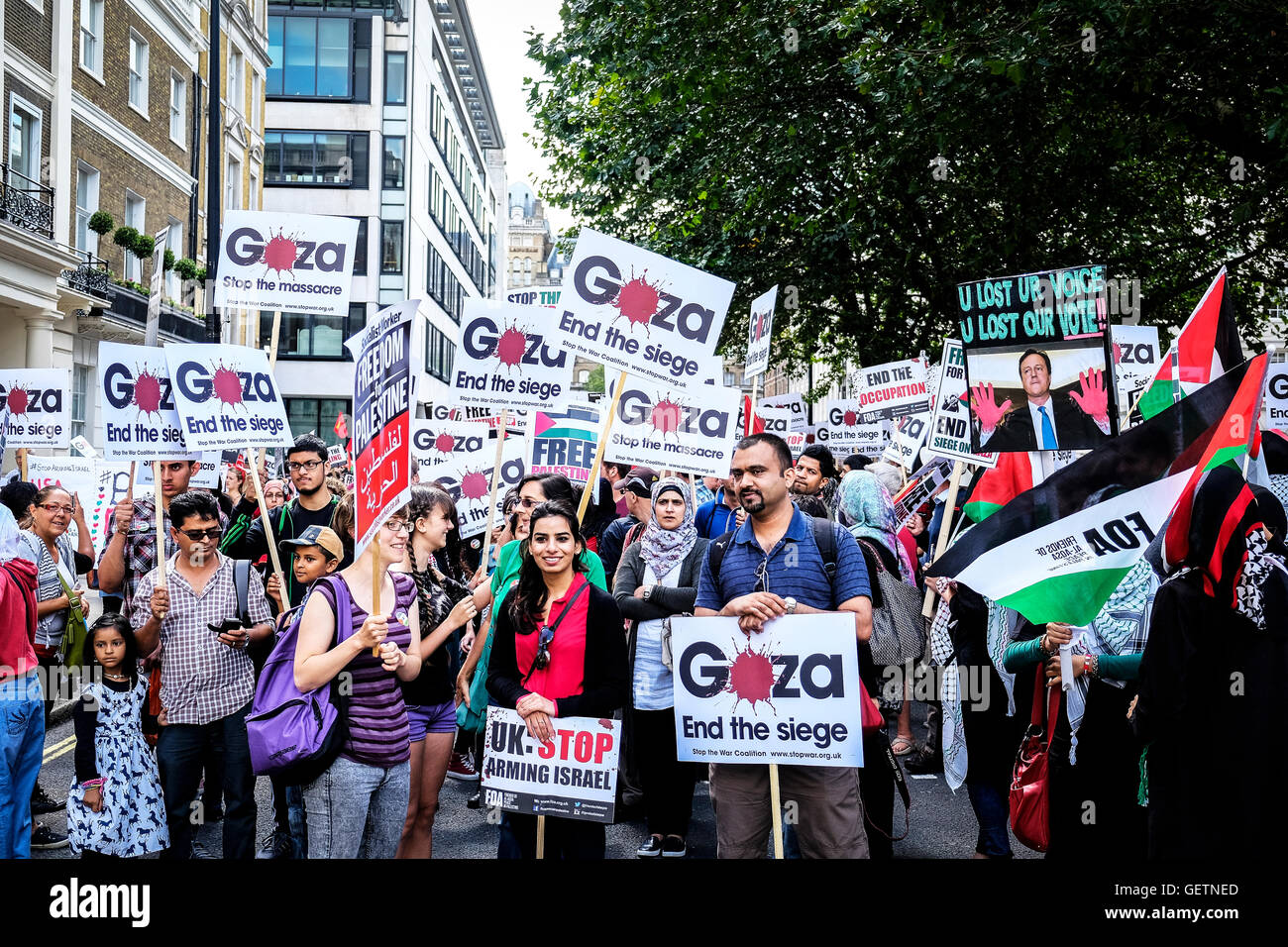 Placards demanding an end to the violence in Gaza being held aloft at a ...