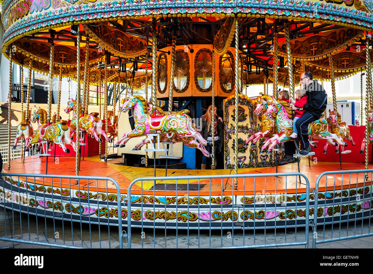 People riding on a traditional carousel Stock Photo - Alamy