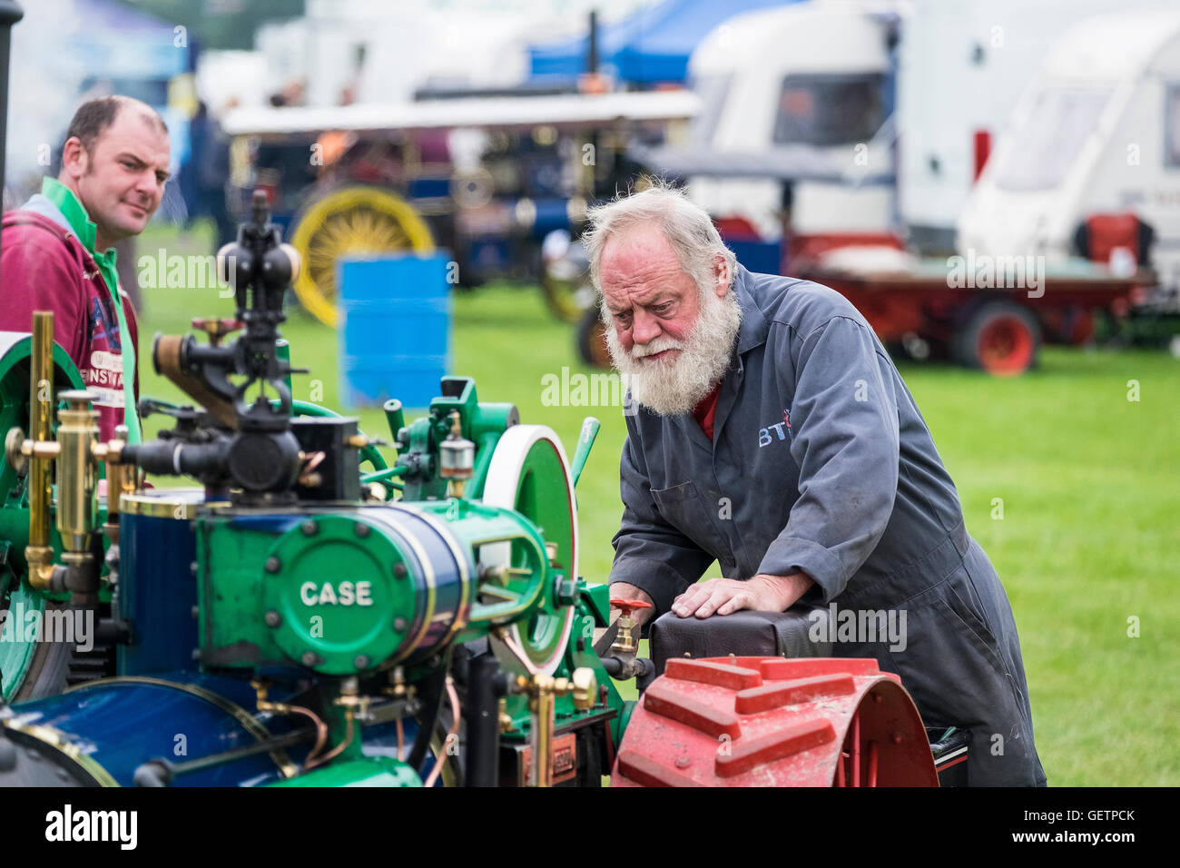 A man carrying out maintenance on his miniature steam engine at the ...
