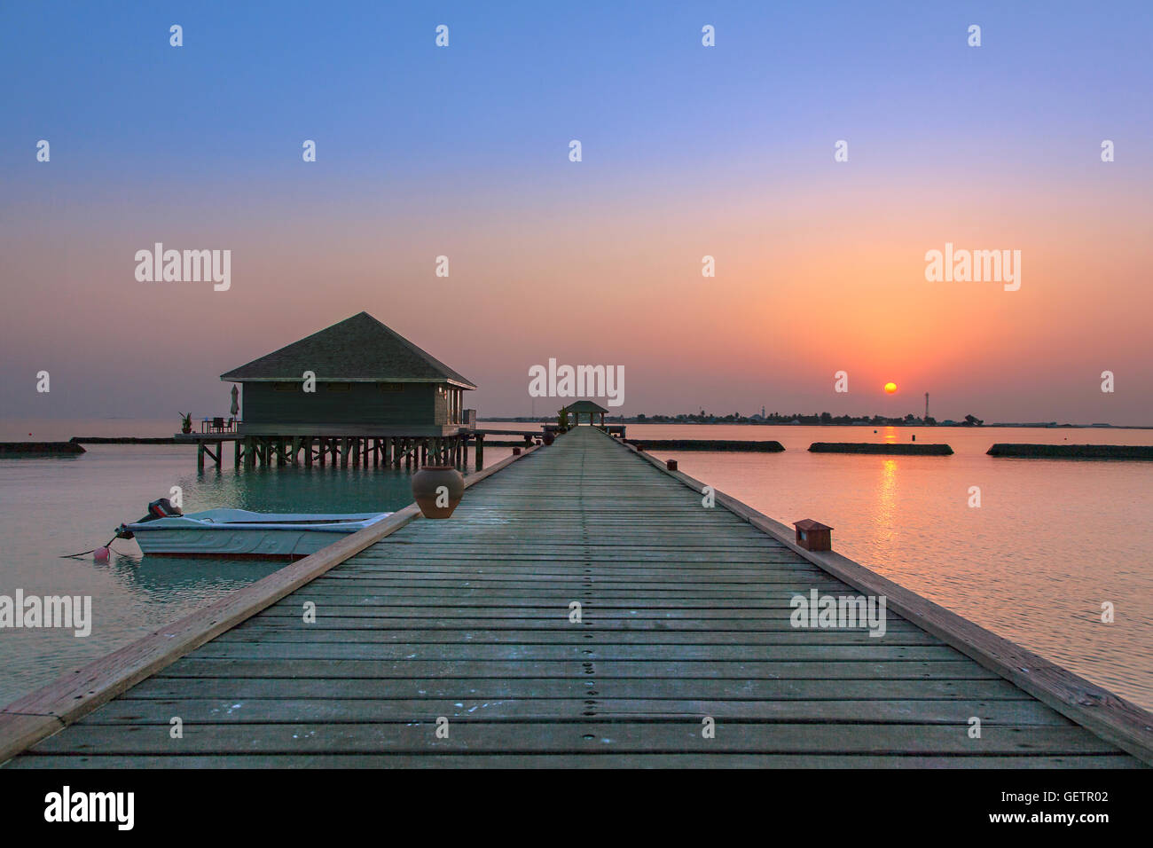 View of the sunset along a boat jetty Stock Photo - Alamy