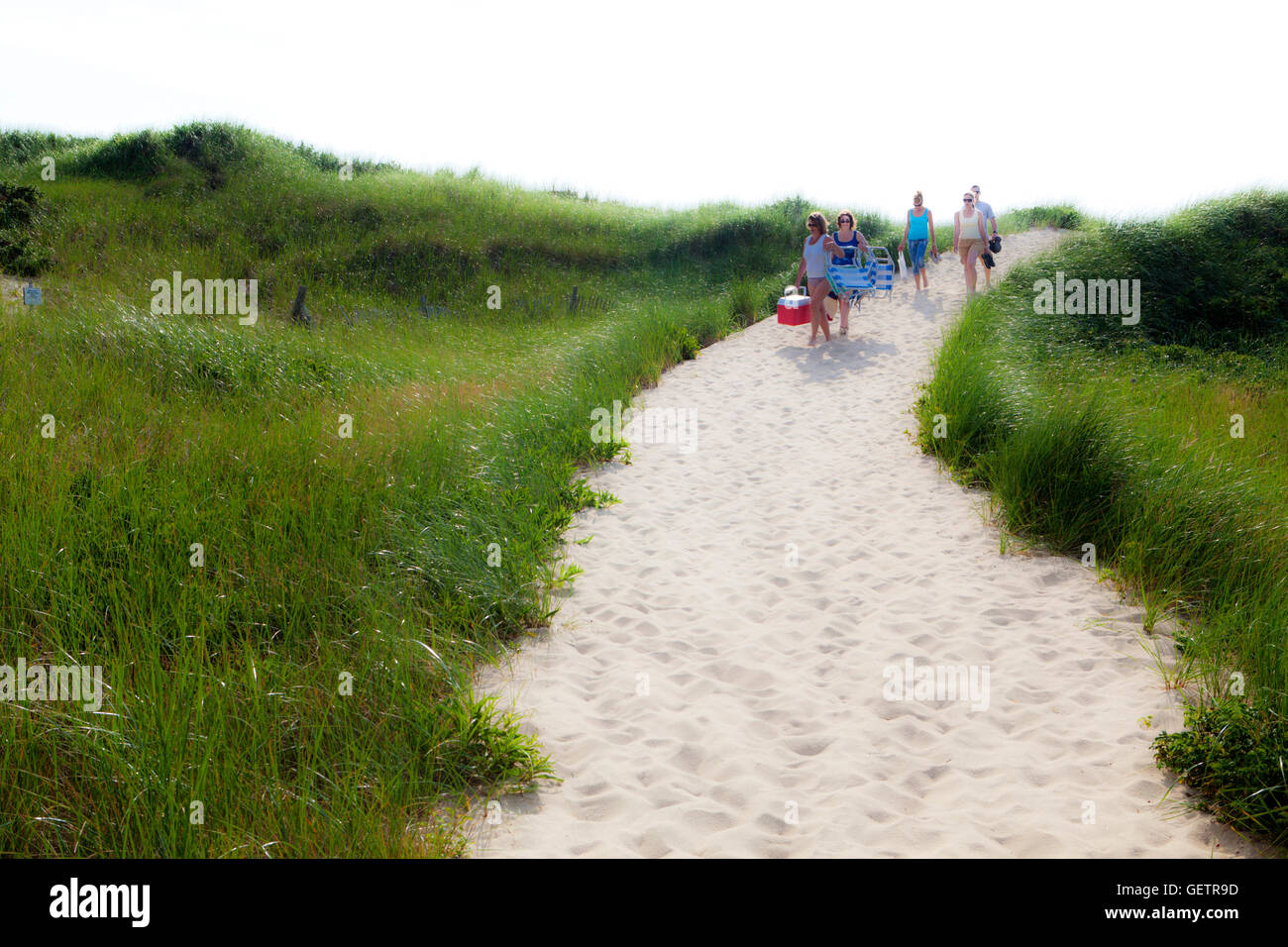 A group of young people leave the beach at Wellfleet in Cape Cod Stock ...