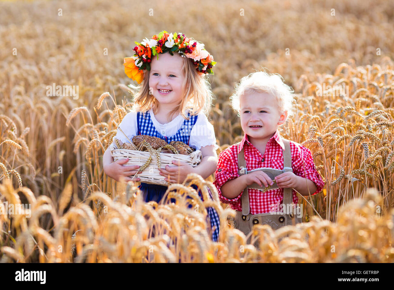 Kids in traditional Bavarian costumes in wheat field. German children ...