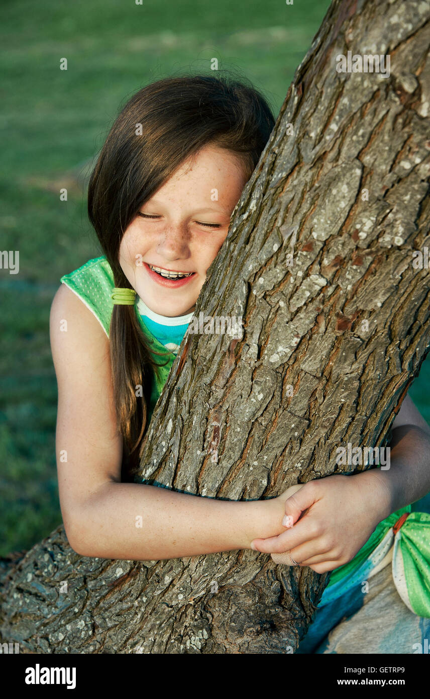 Girl hugging a tree Stock Photo - Alamy