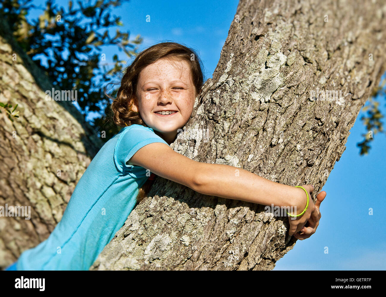 Girl hugging a tree Stock Photo - Alamy