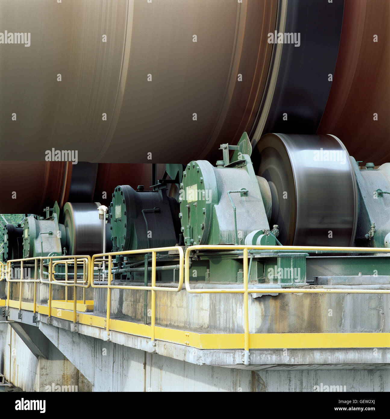 Motors and rollers that drive the kiln in a cement plant Stock Photo ...