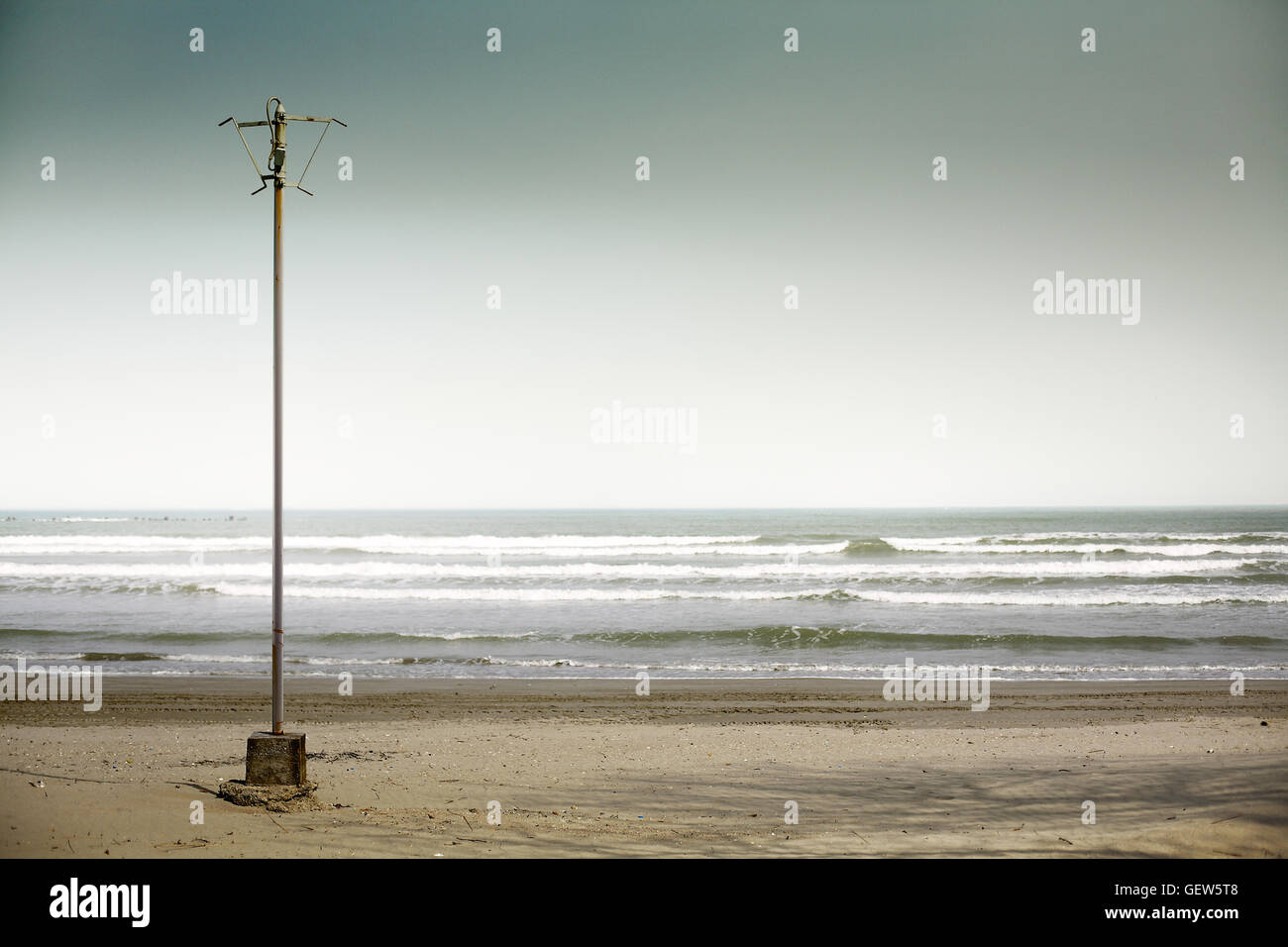 Broken lantern on a beach in front of wavy sea and sky Stock Photo - Alamy