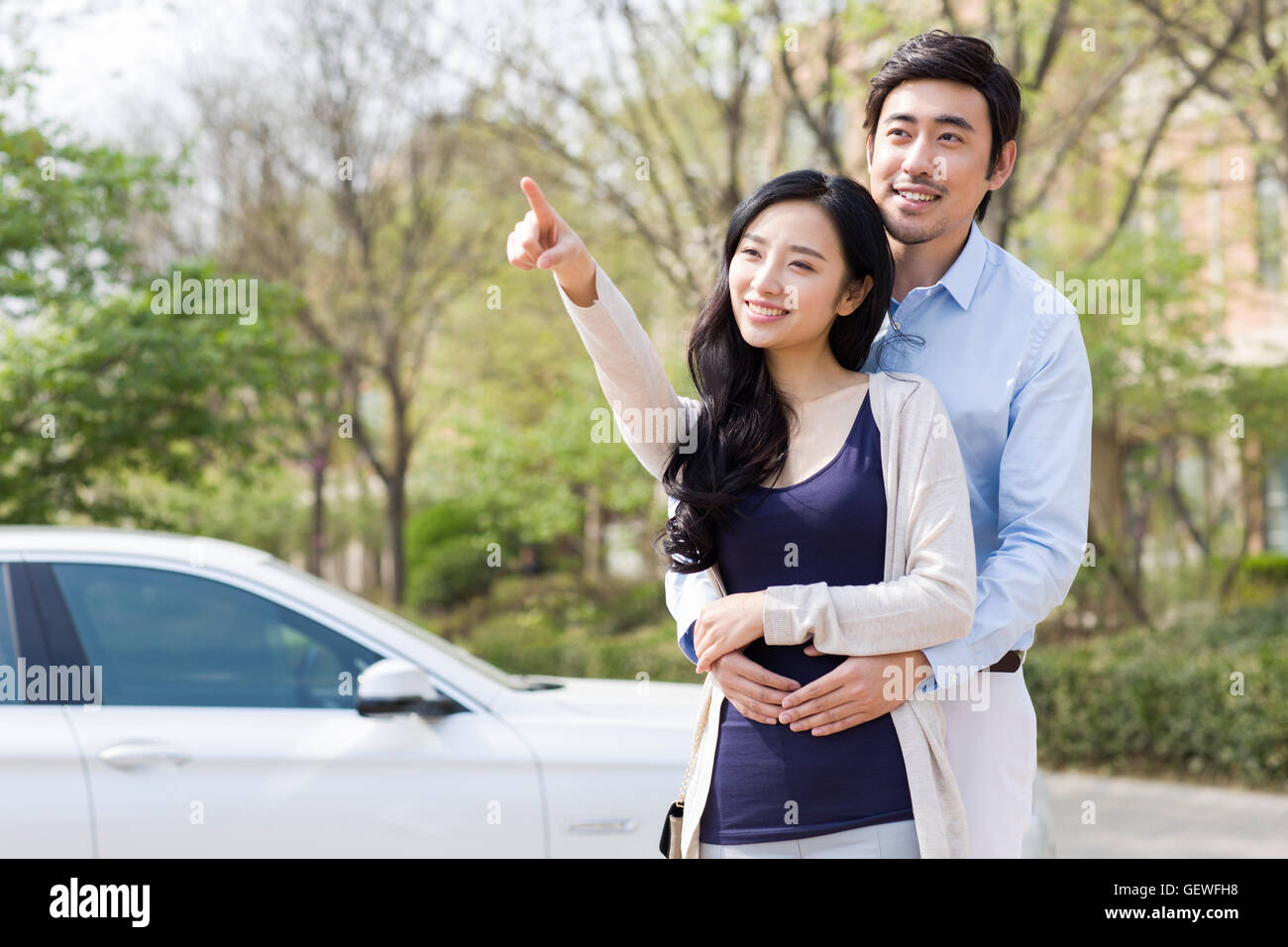 Happy young Chinese couple and car Stock Photo - Alamy
