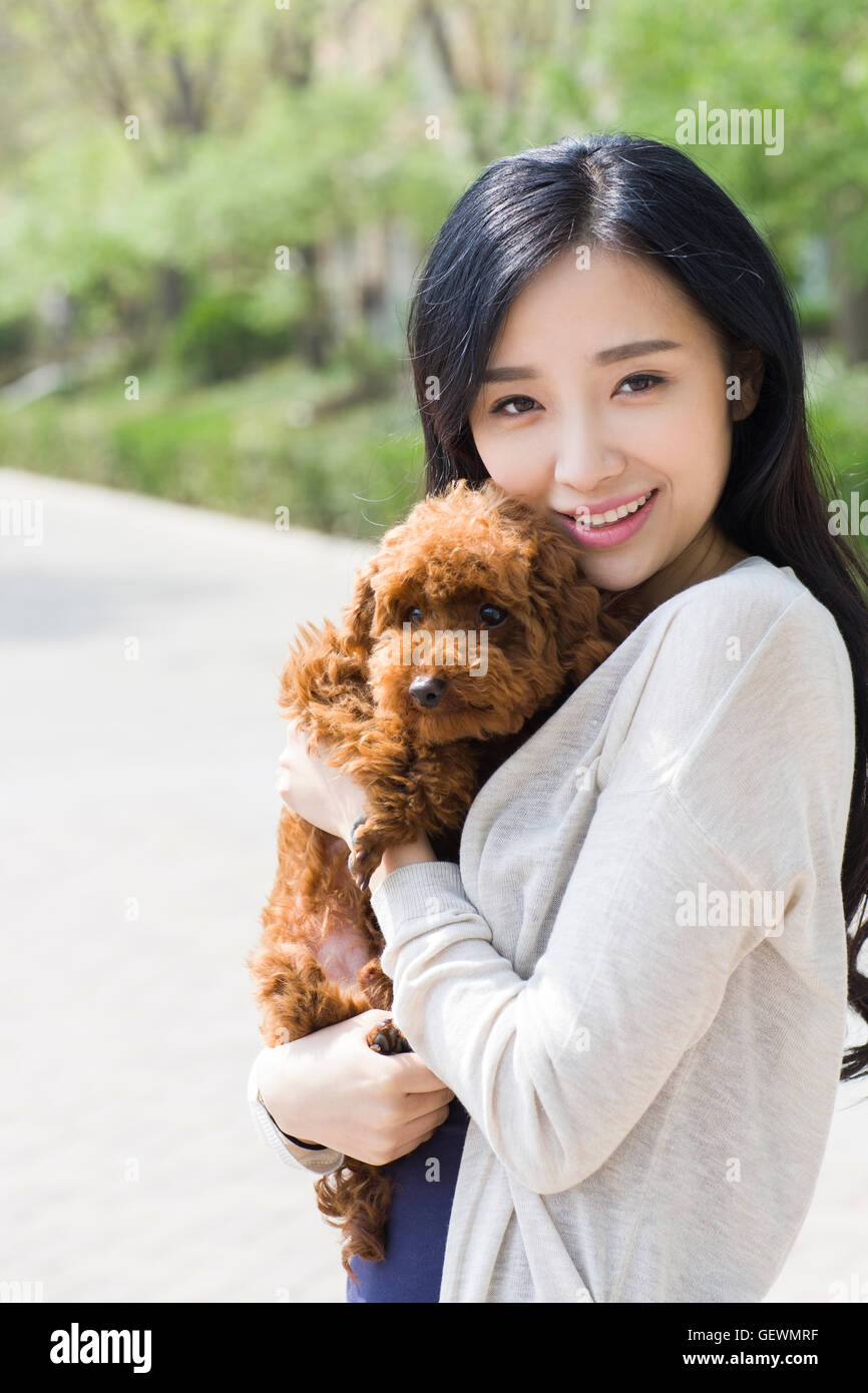 Happy young Chinese woman with her pet dog Stock Photo - Alamy