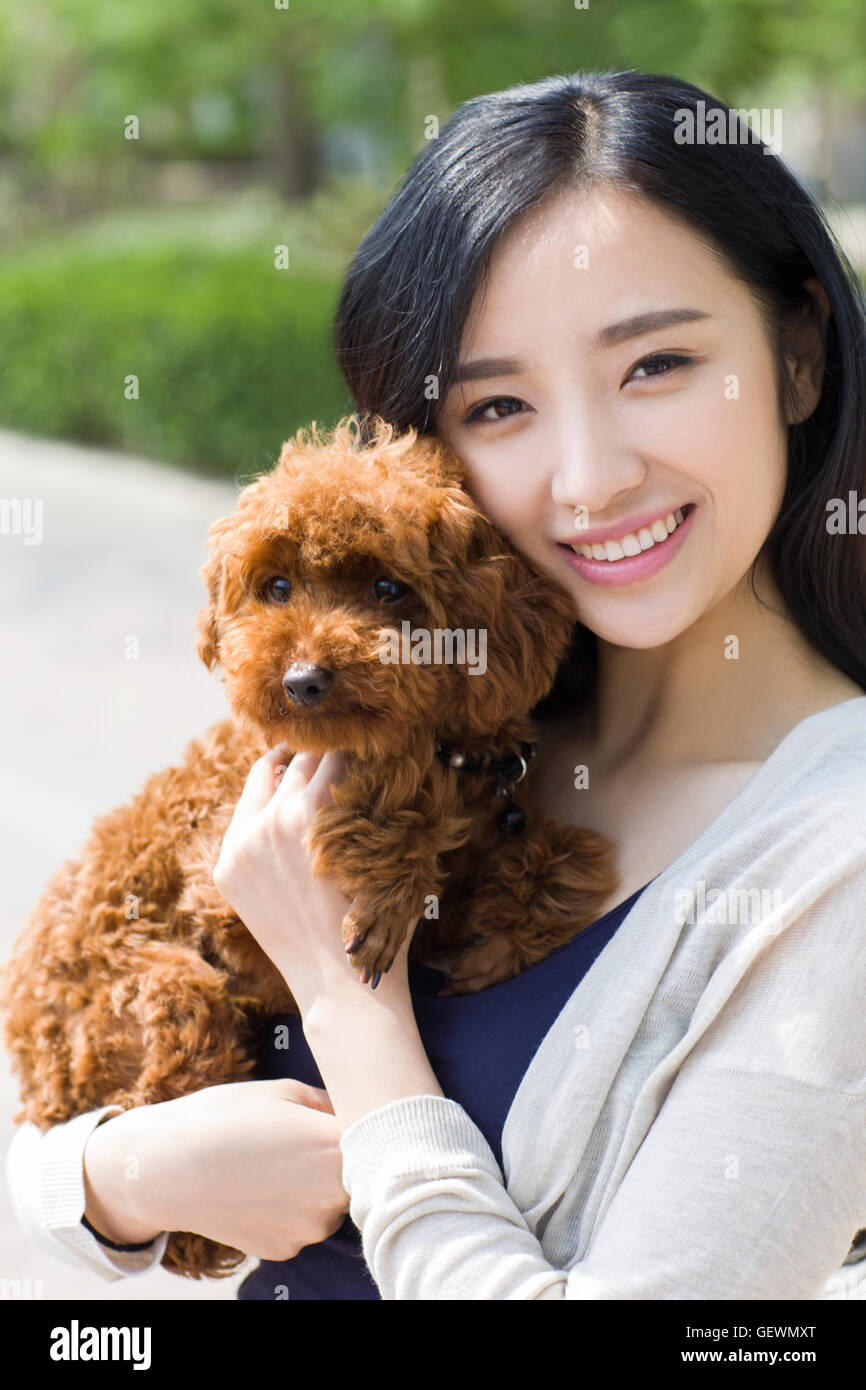 Happy young Chinese woman with her pet dog Stock Photo - Alamy
