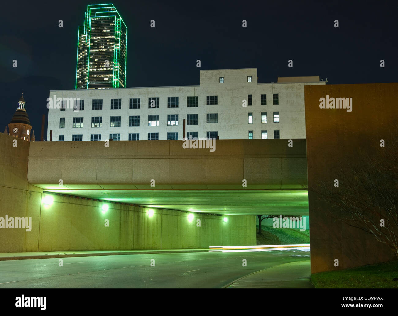 Underpass with brightly lit buildings above Stock Photo - Alamy