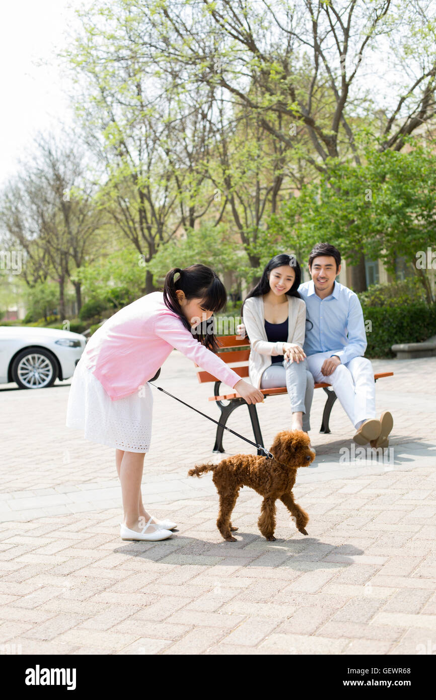 Happy young Chinese family with their pet dog Stock Photo - Alamy
