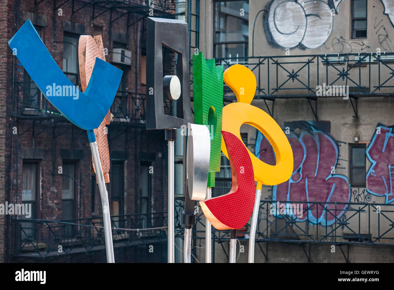 Detail of colourful sculptural building sign with graffiti in ...