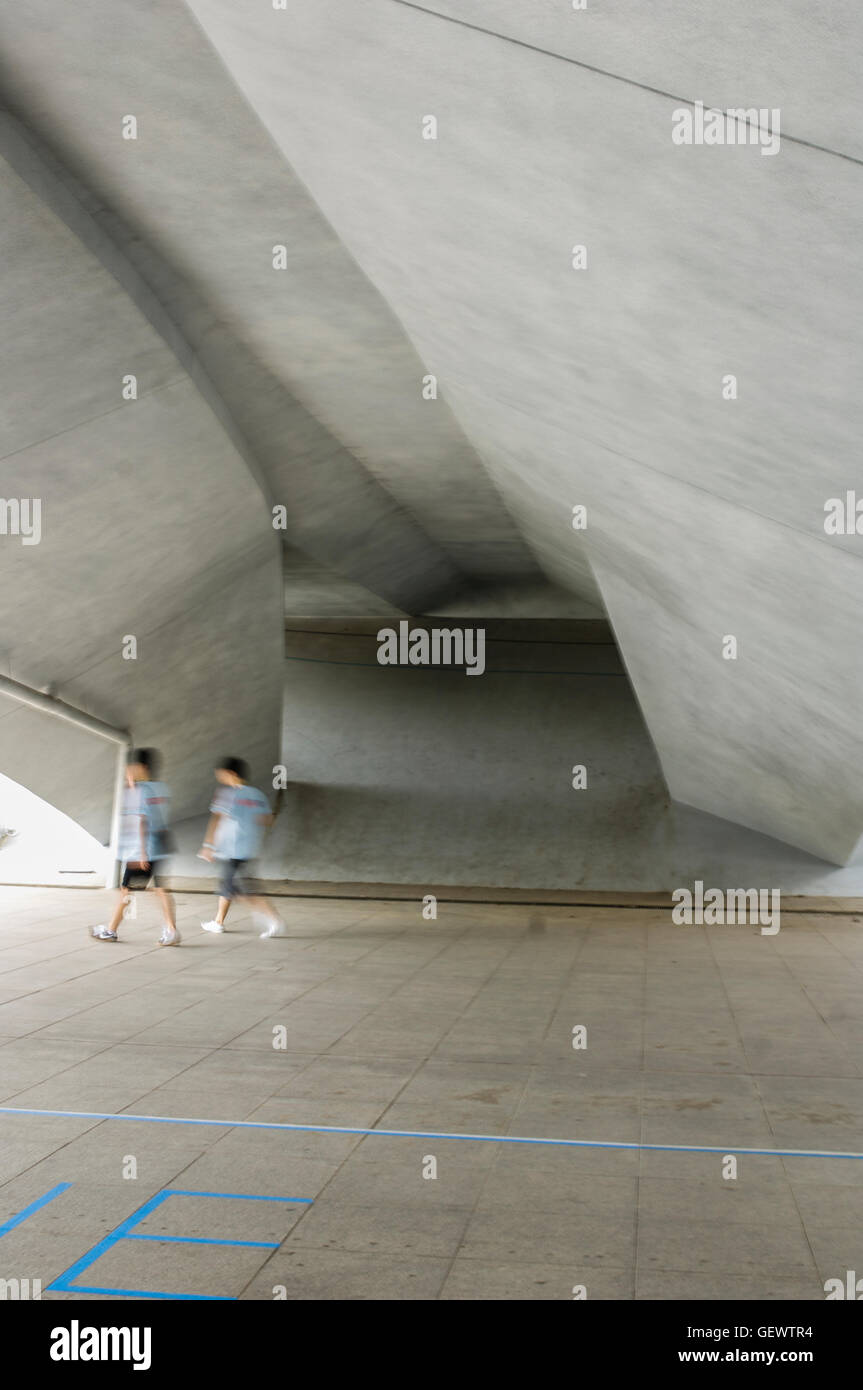 Two men walking under a bridge in Marina Bay Stock Photo - Alamy