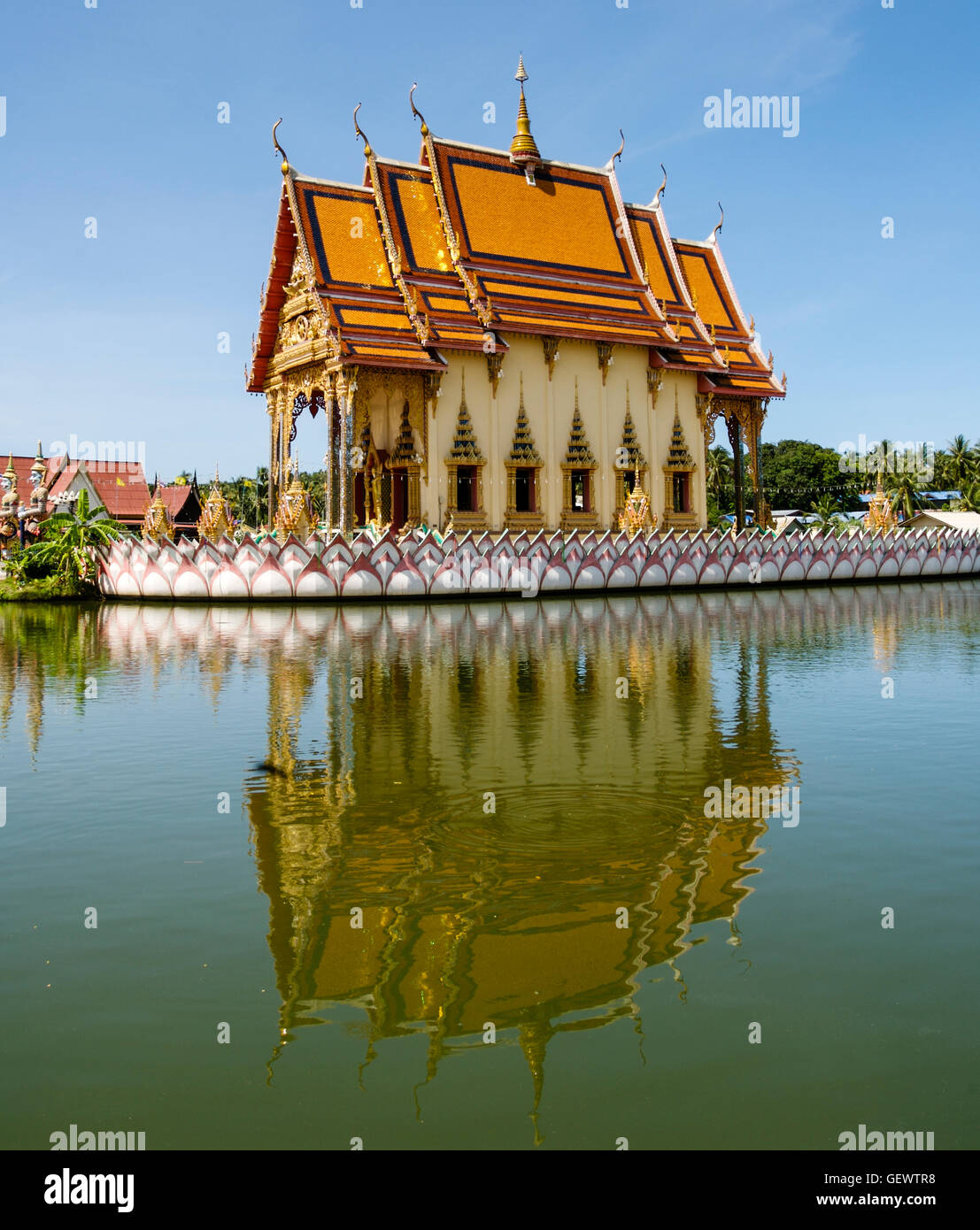 Buddhist temple reflected in lake Stock Photo - Alamy
