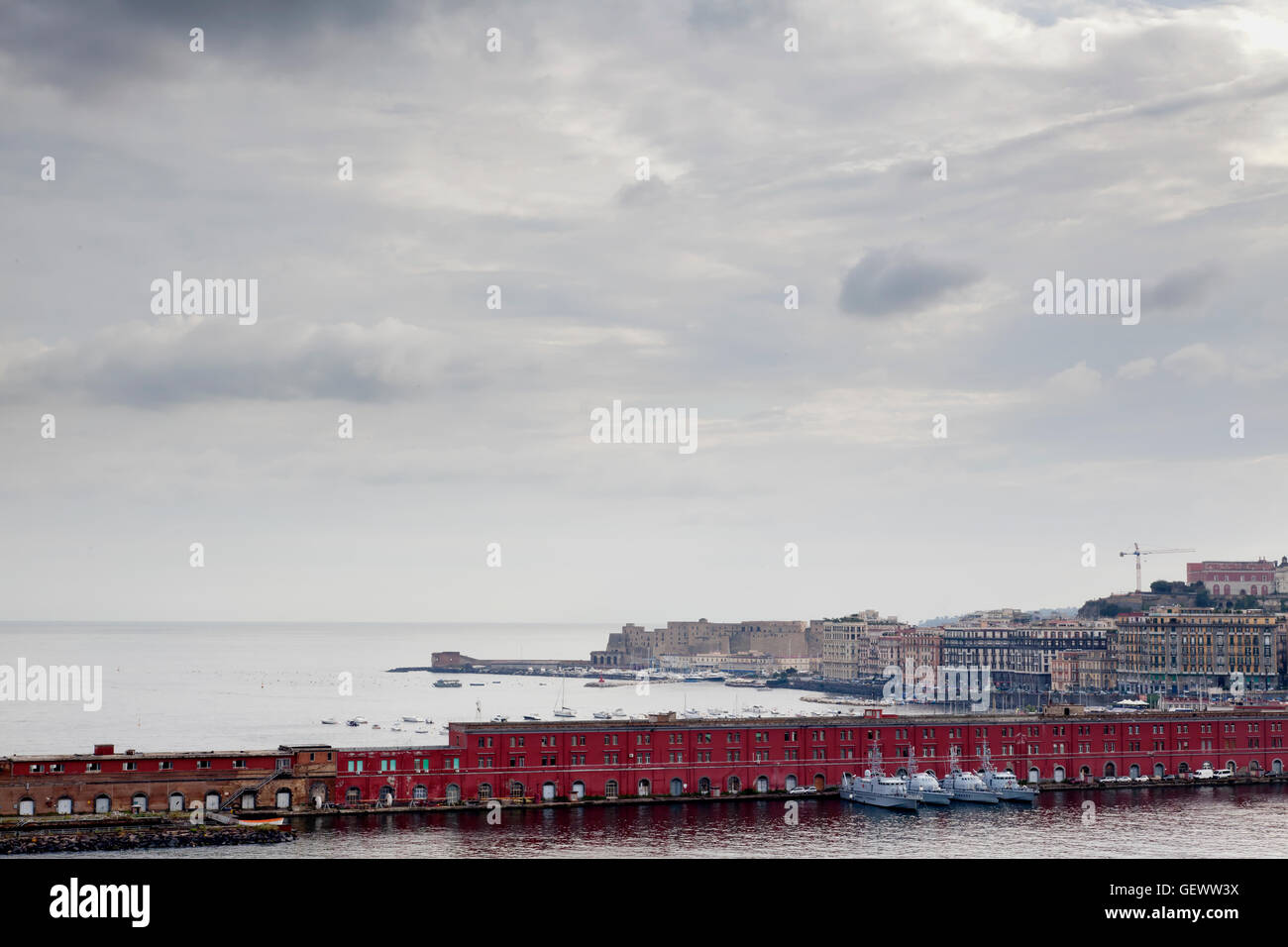 Waterfront and red harbour buildings in Naples in Italy Stock Photo - Alamy