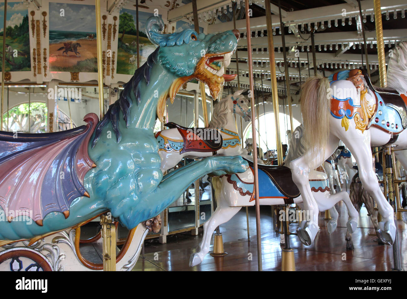 A vintage carousel with white horses Stock Photo - Alamy