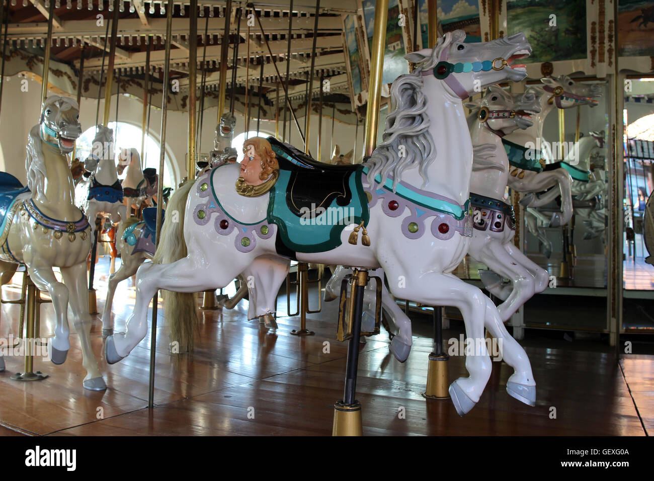 A vintage carousel with white horses Stock Photo - Alamy