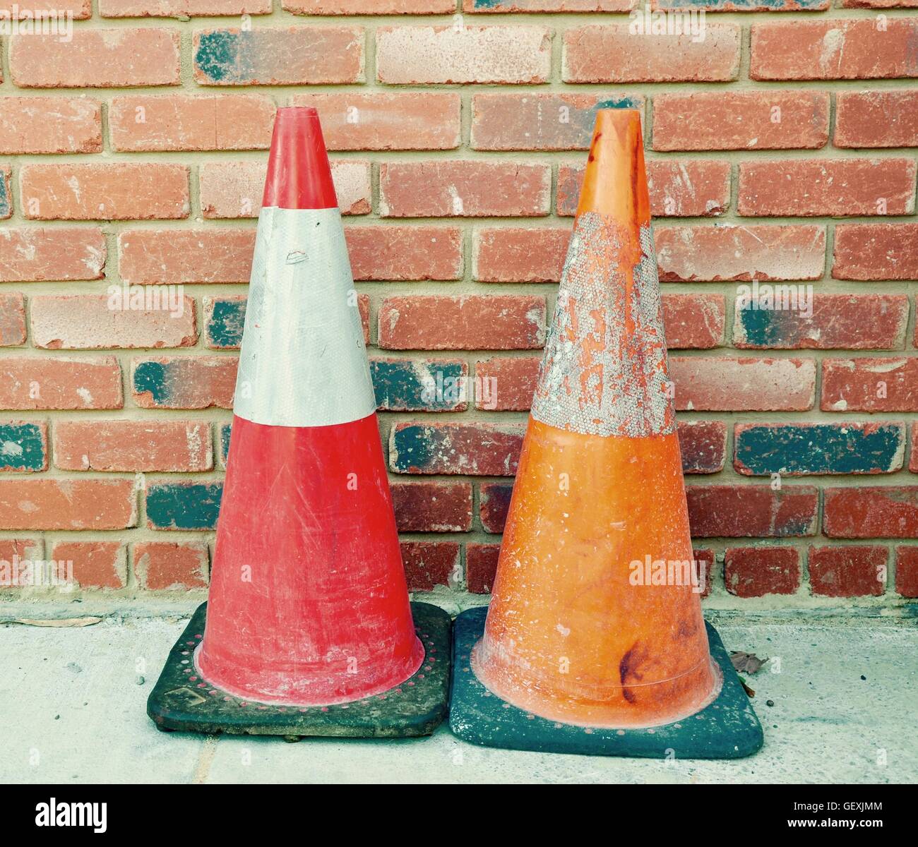Two construction safety cones, red and orange with reflectors, isolated ...