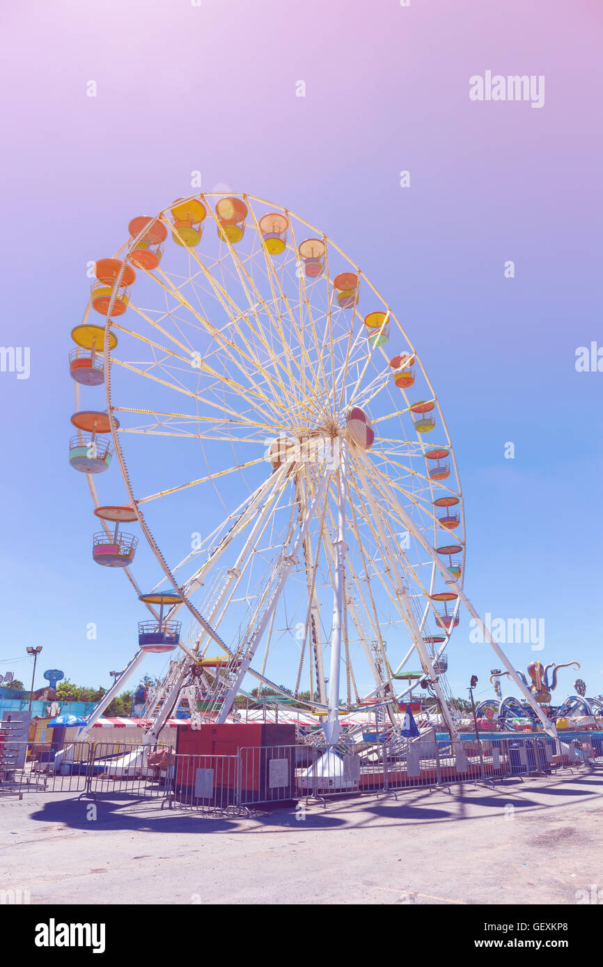 Giant ferris wheel in Amusement park with blue sky background pastel ...