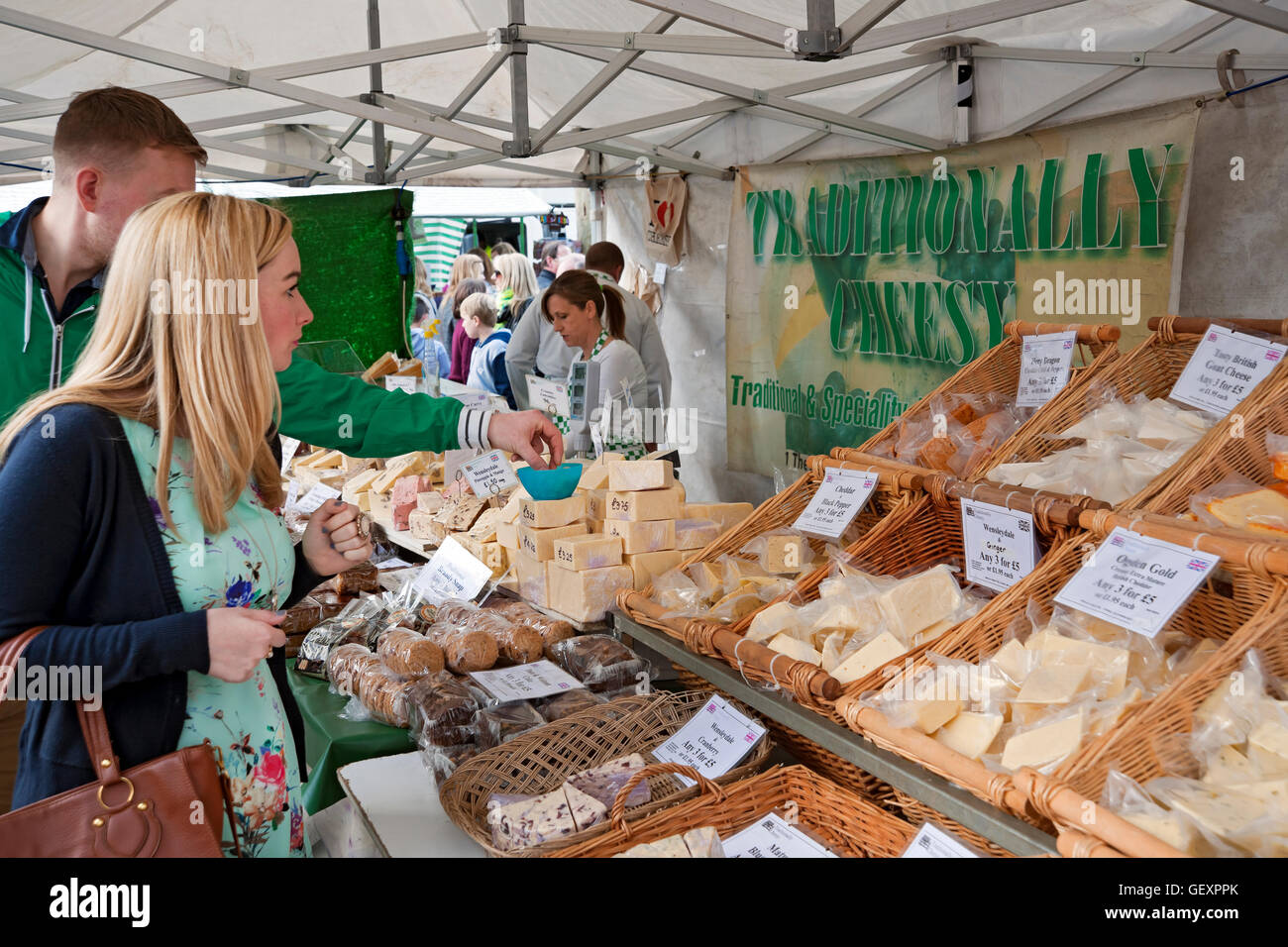 People sampling cheese on market stall Stock Photo - Alamy