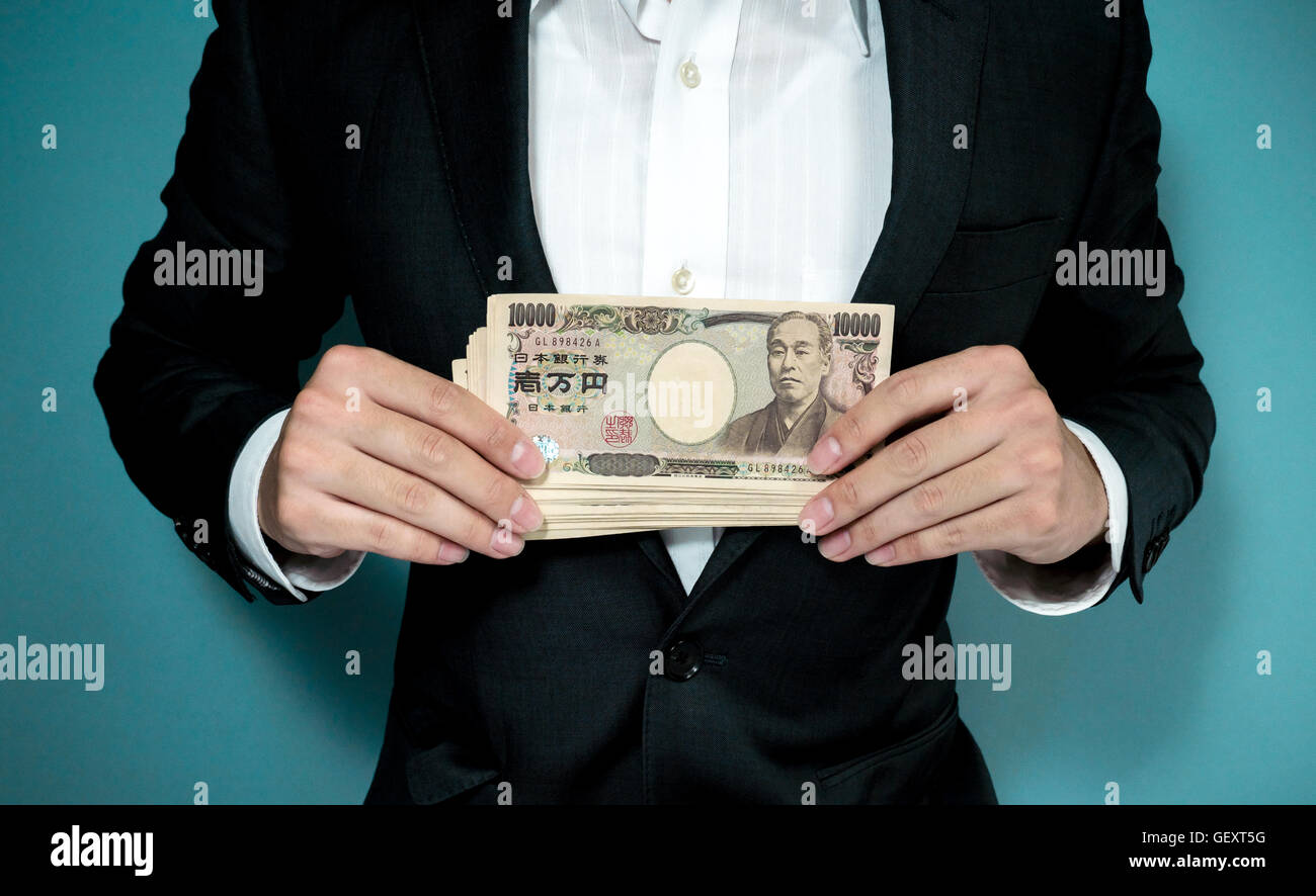 Businessman holding a lot of ten thousands yen Stock Photo - Alamy