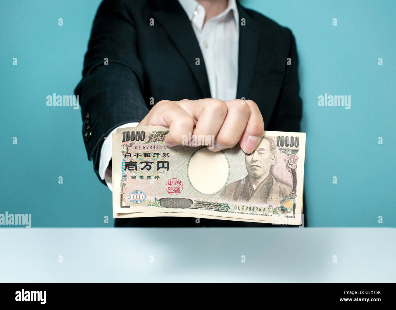 Businessman holding a lot of ten thousands yen Stock Photo - Alamy