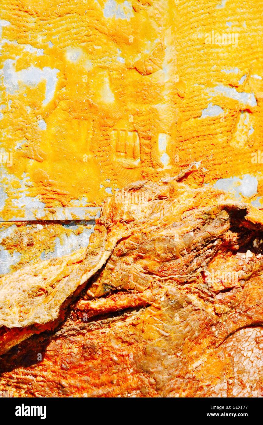 Closeup abstract of a rusted light pole with rusted glue and fabric in ...