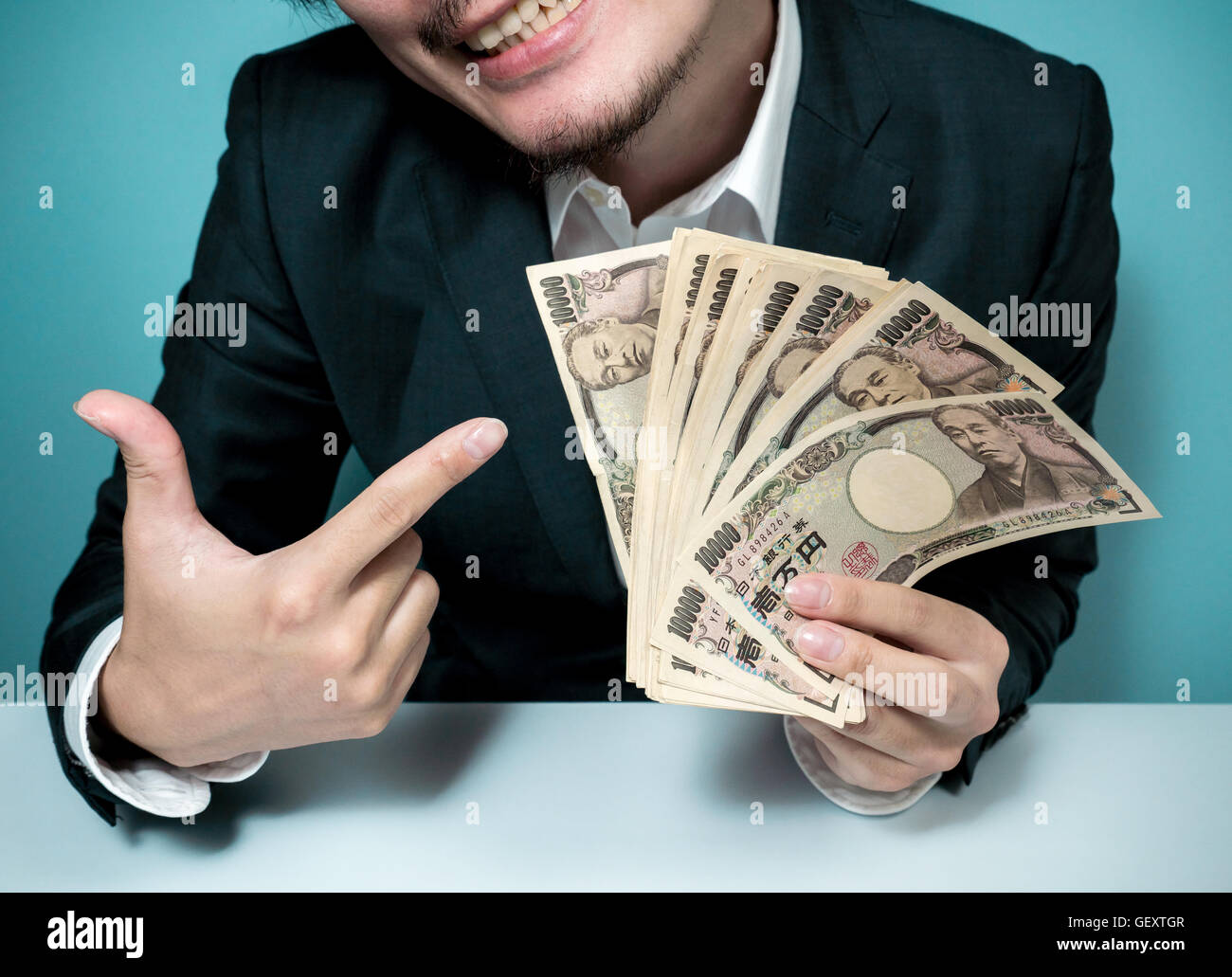 Businessman holding a lot of ten thousands yen Stock Photo - Alamy