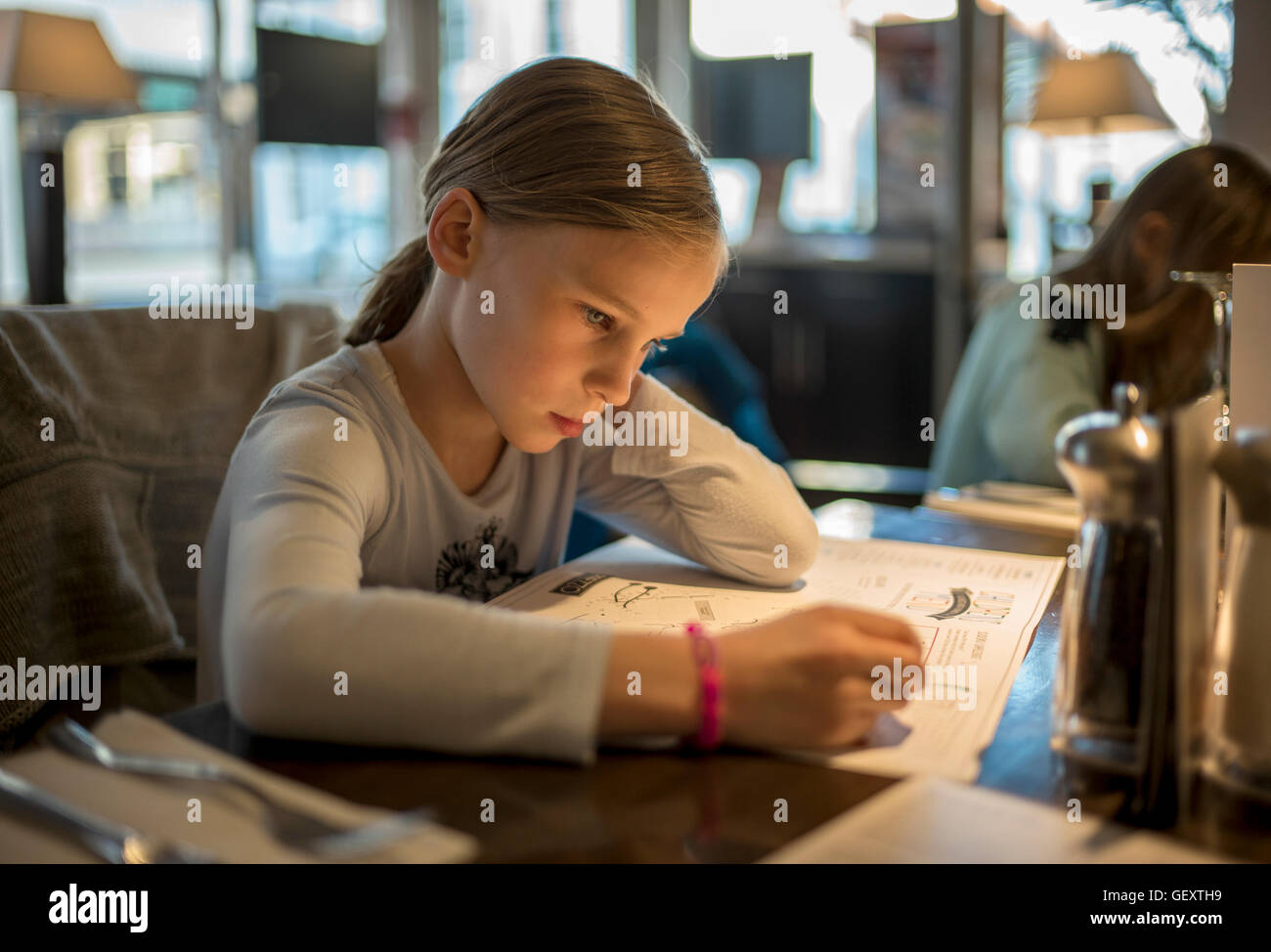 Child colouring in a menu at a pizza restaurant Stock Photo - Alamy