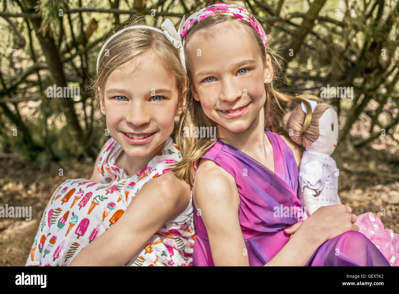 Twin sisters playing in the woods and smiling for the camera Stock ...