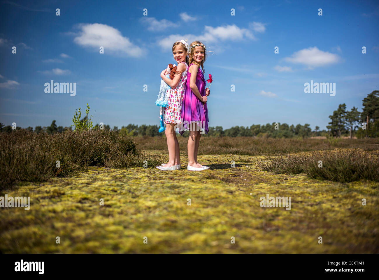 Identical twin sisters play together in the open air Stock Photo - Alamy