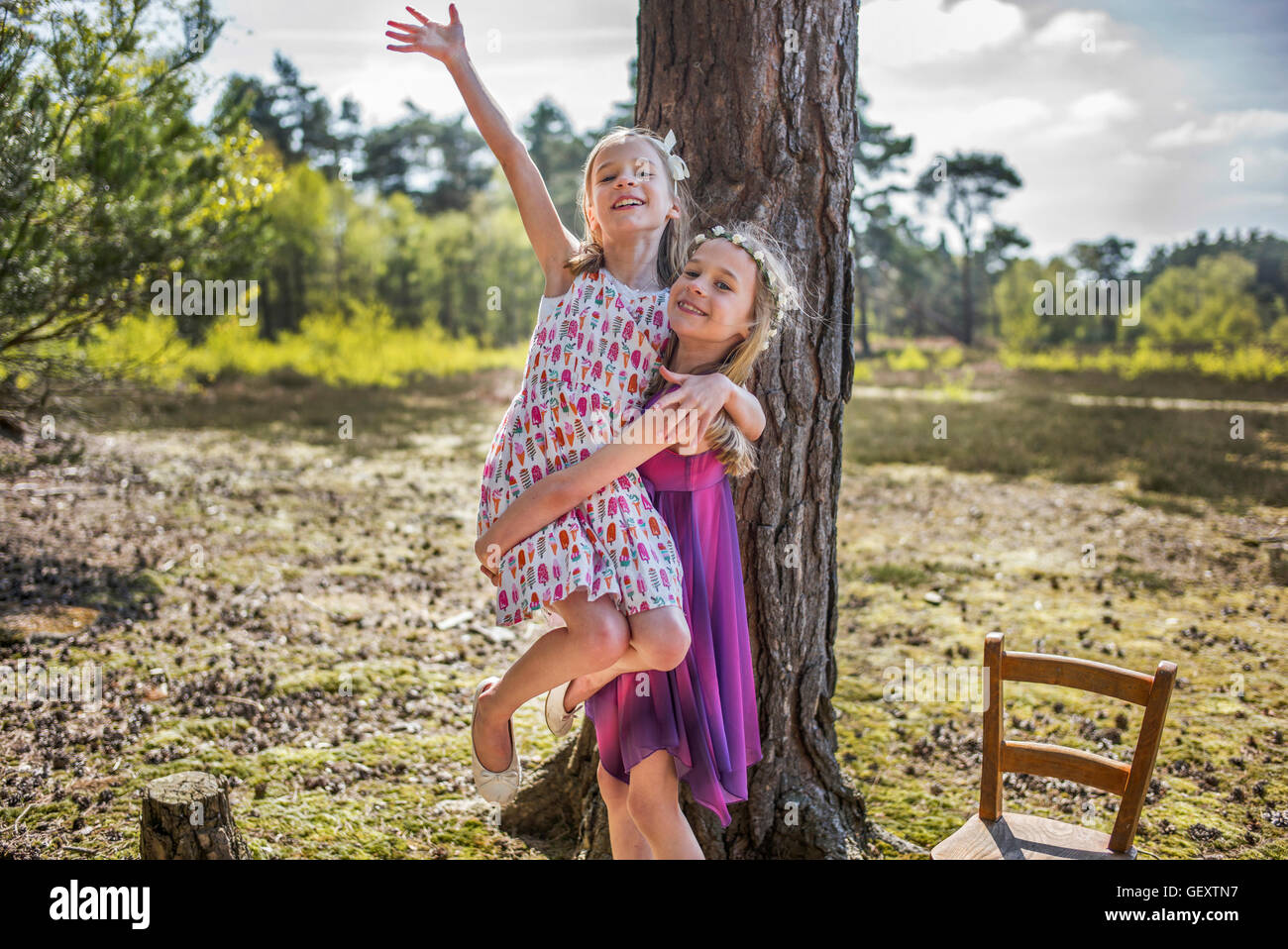 Twin sisters playing in the woods Stock Photo - Alamy