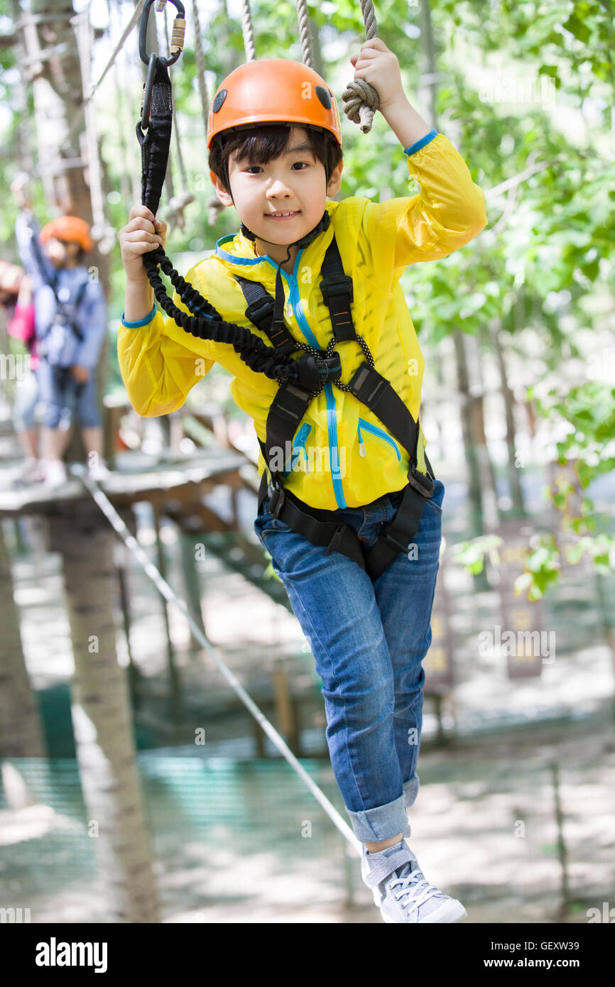 Happy Chinese children playing in tree top adventure park Stock Photo ...